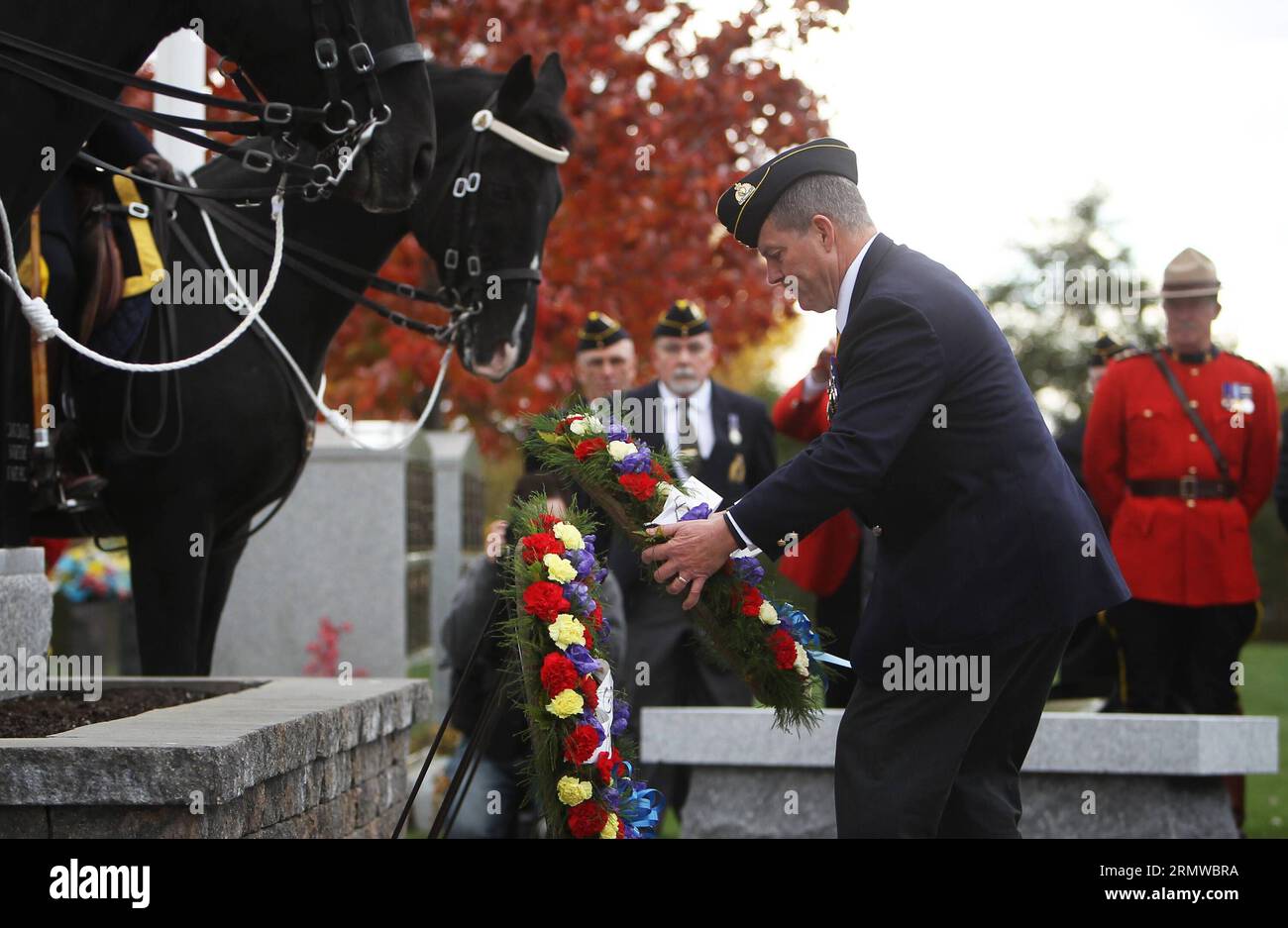 A wreaths is laid by the Graham Muir, president of the RCMP veterans ...