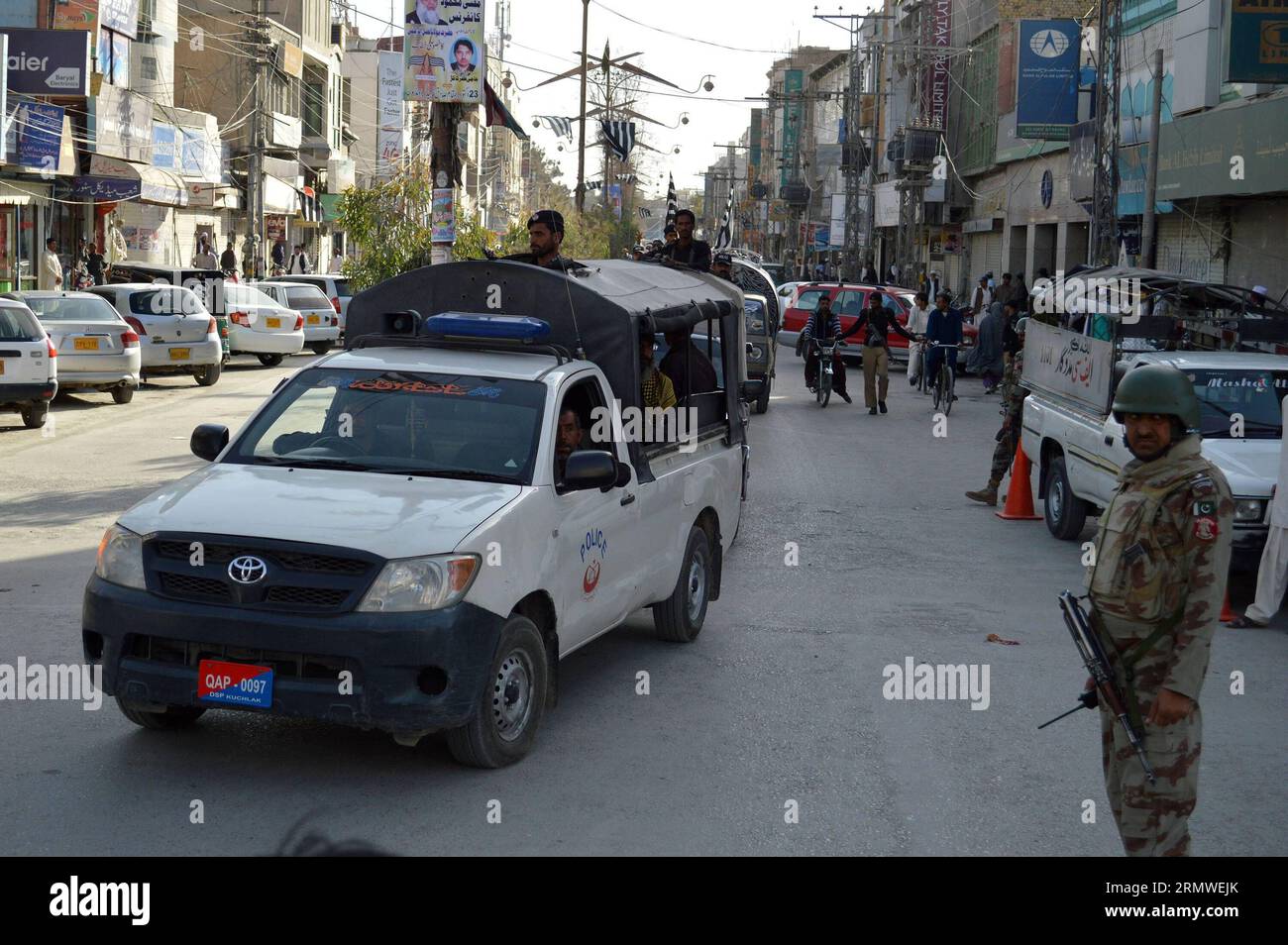 Pakistani policemen and soldiers patrol on the road due to high-level ...