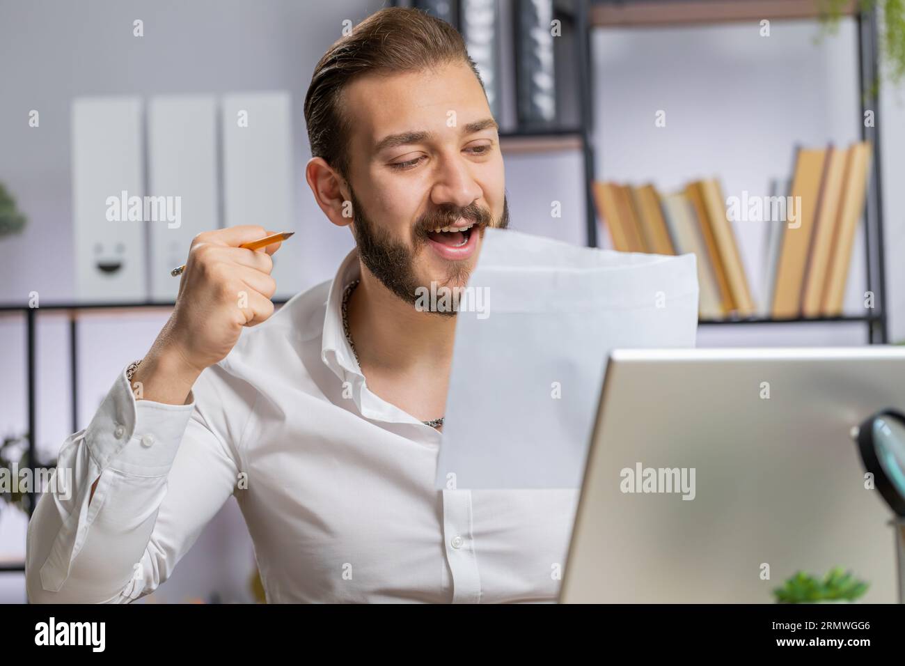 Lebanese business man open envelope letter, reading it. Career growth advance promotion, bank ...