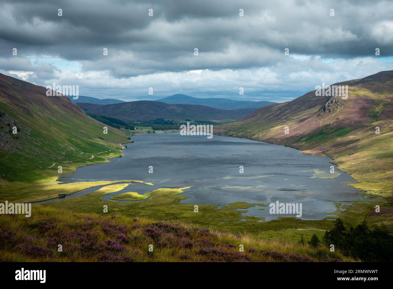 An Aerial view of Loch Lee surrounded by lush green during a cloudy ...