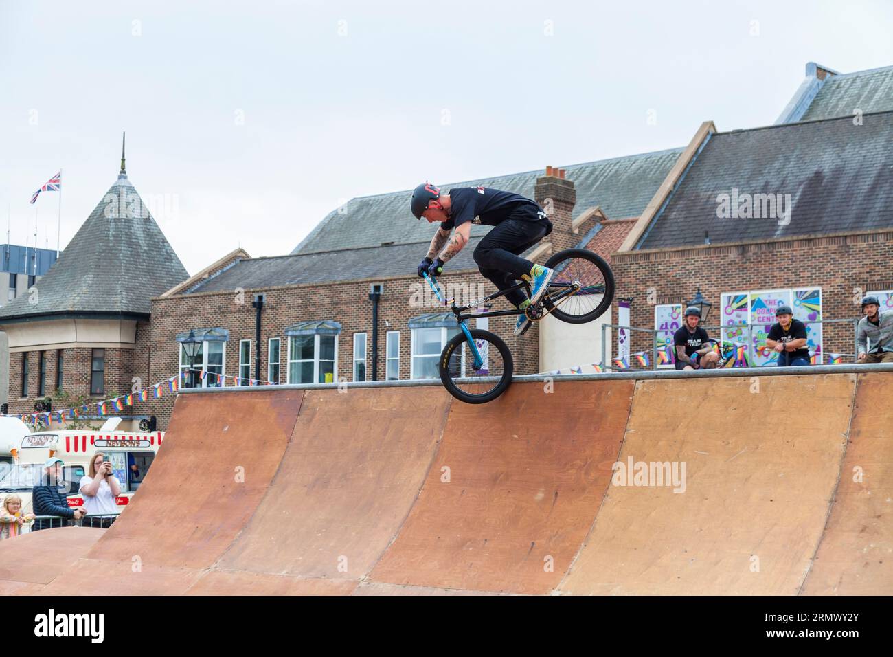 A youth on a BMX bike in mid air performing aerial stunts in a BMX ...