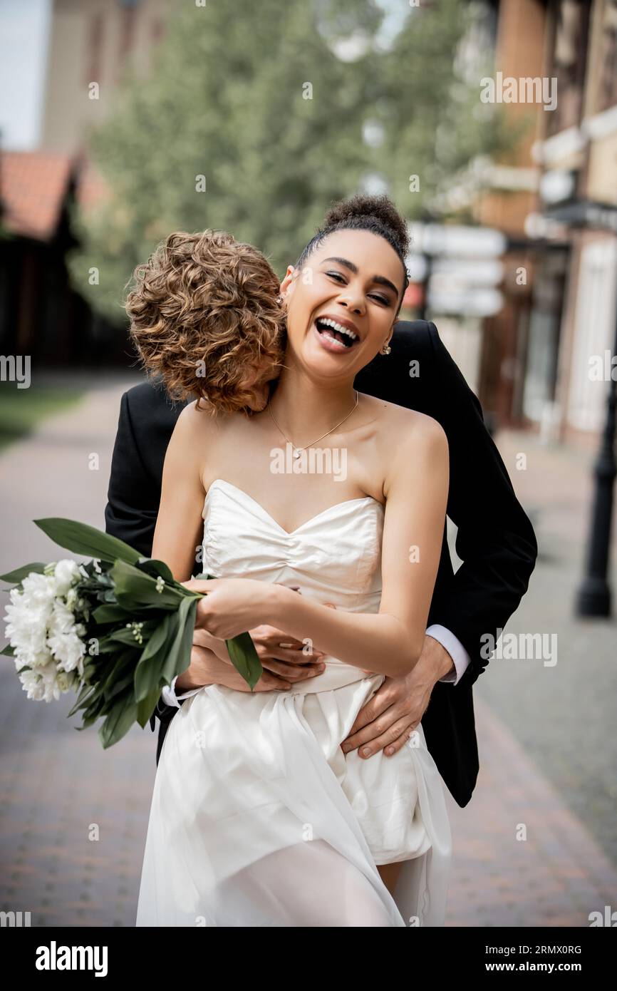 Happy diverse bride groom laughing hi-res stock photography and images ...