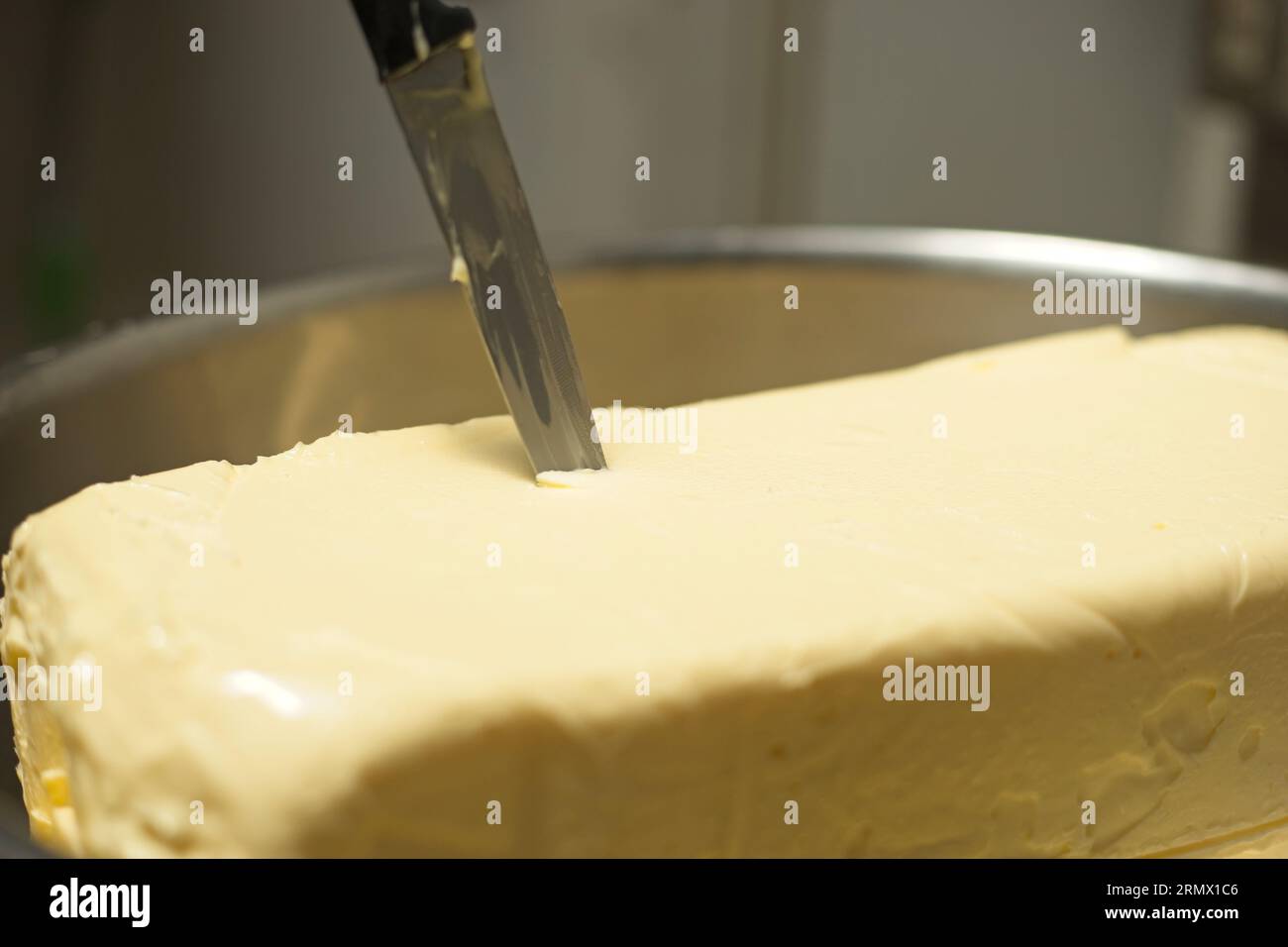Butter block in the bit bowl, with a knife on top Stock Photo - Alamy