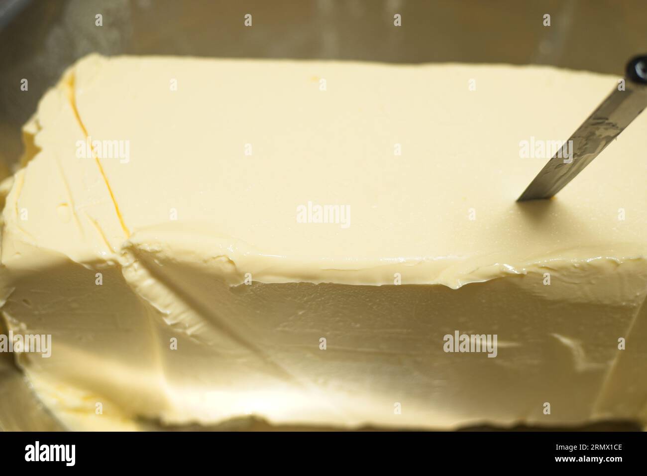 Butter block in the bit bowl, with a knife on top Stock Photo - Alamy
