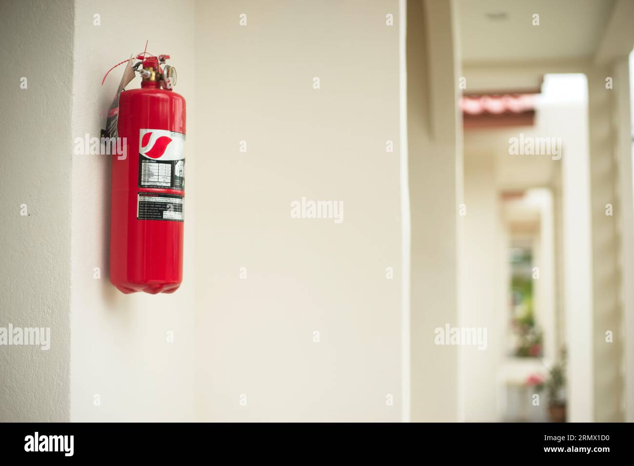 Fire extinguisher hanging on the wall of the hotel corridor, the symbol ...