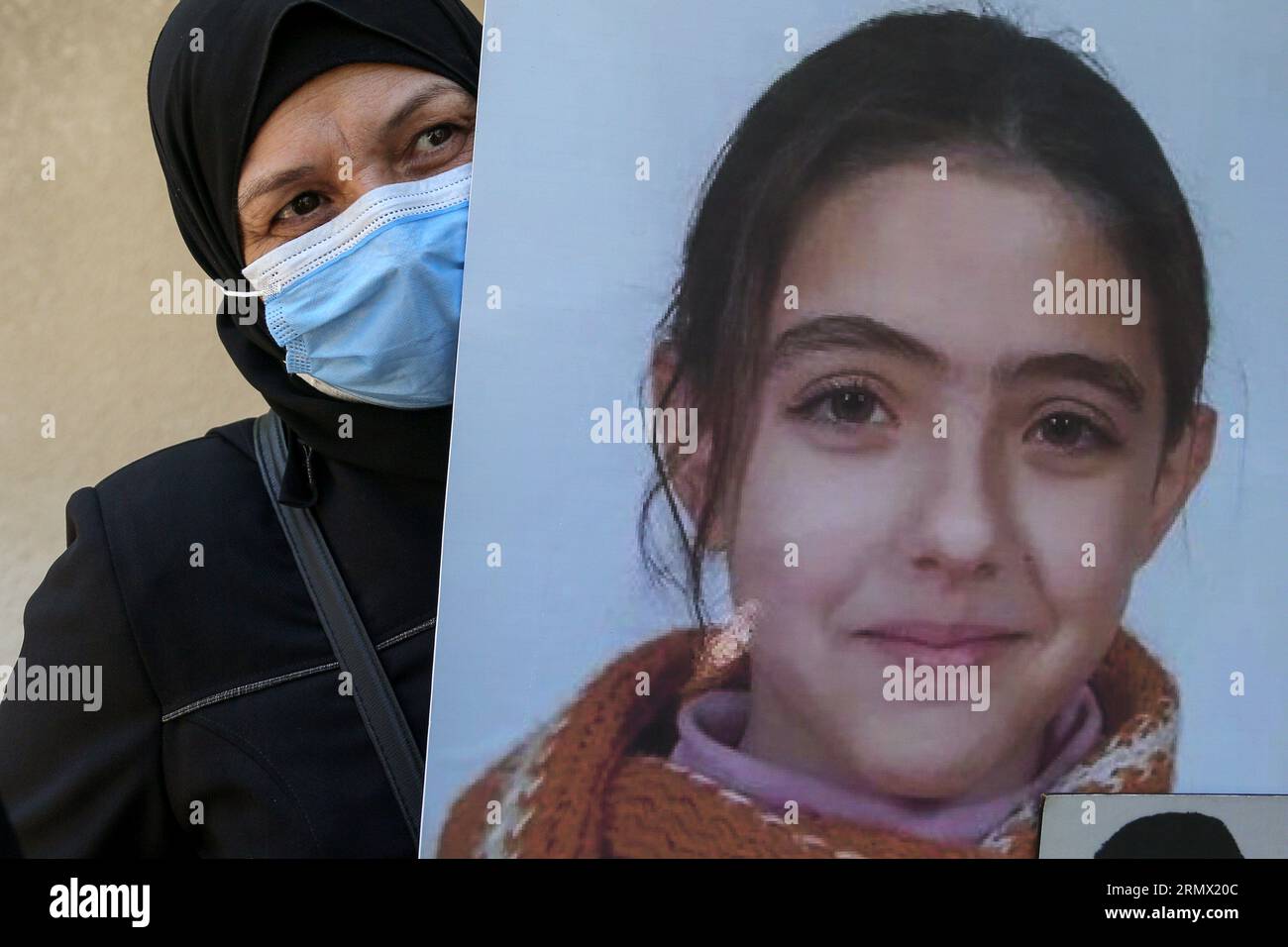 Beirut, Lebanon. 30th Aug, 2023. A Syrian woman holds the picture of ...