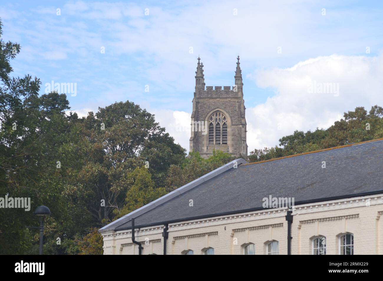 An areal shot of a clock tower situated atop a building, seen in the ...