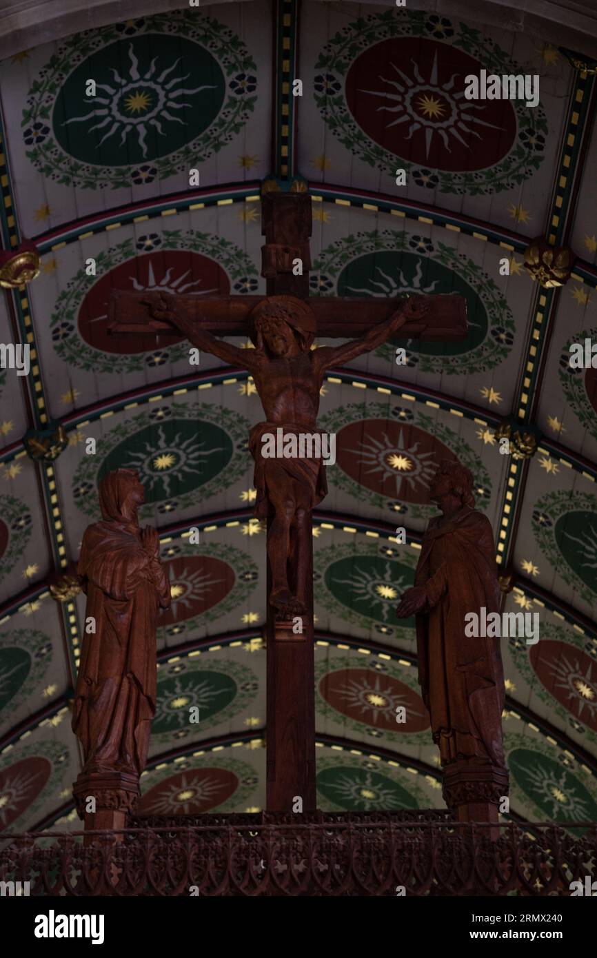 Jesus Christ on a cross inside of a church building with golden ...