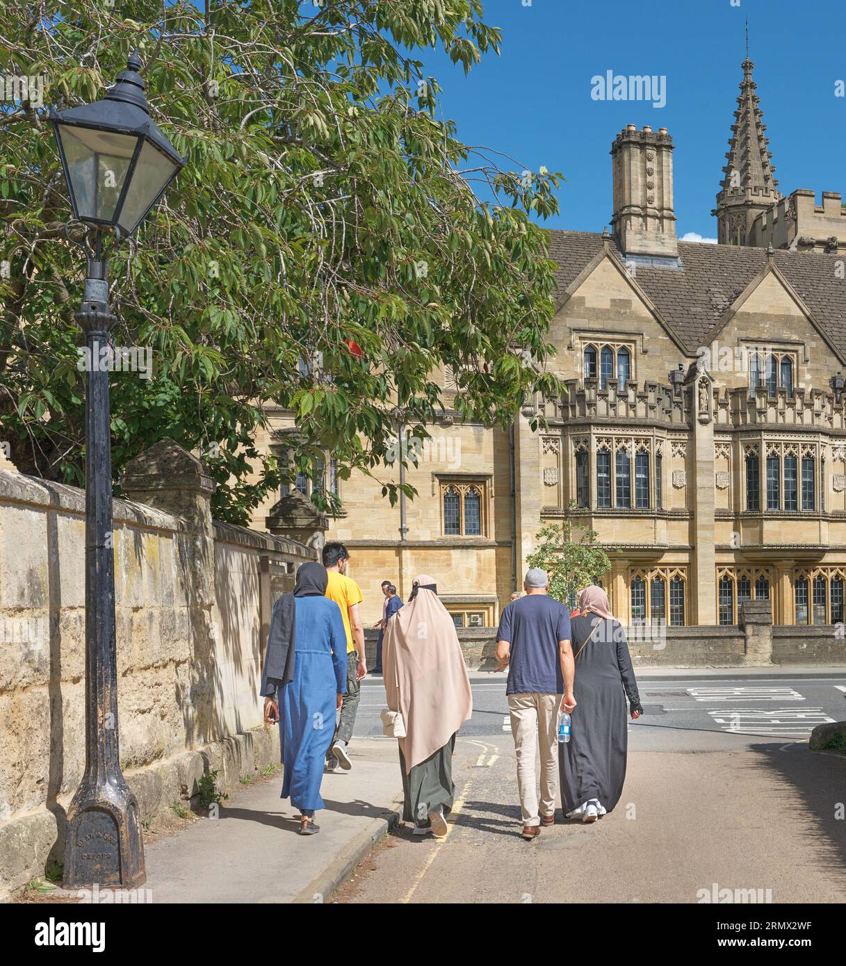 A group of muslim men and women (with abaya) tourists outside Magdalen ...