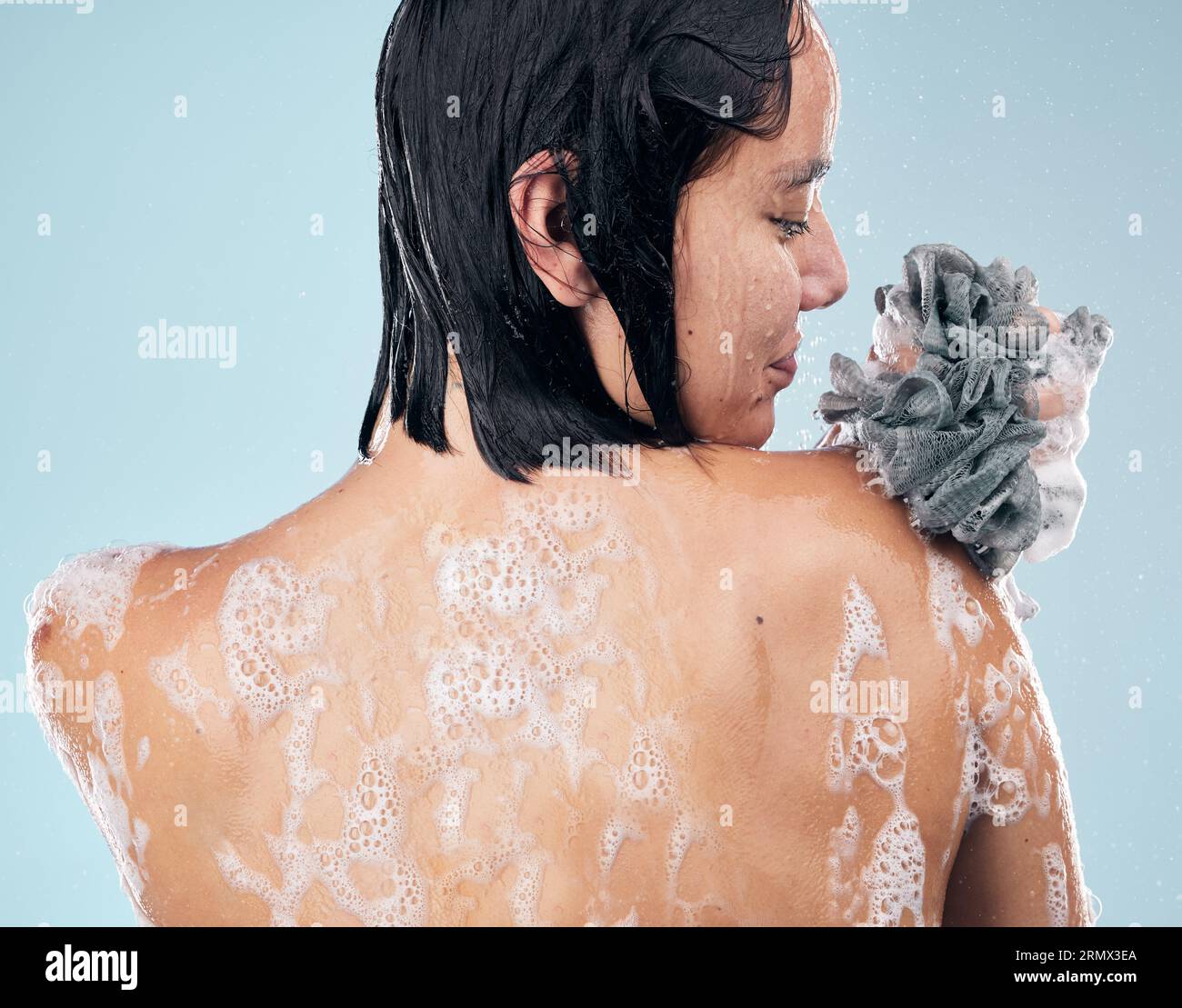 Woman, back and cleaning body with water, soap and sponge for ...