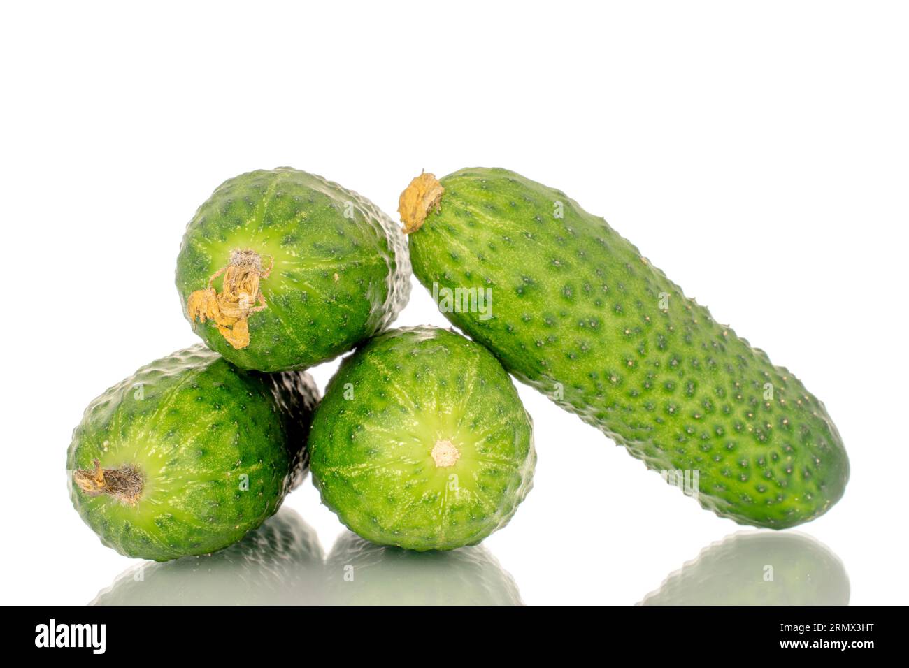 Four fresh green cucumbers, macro, isolated on white background Stock ...