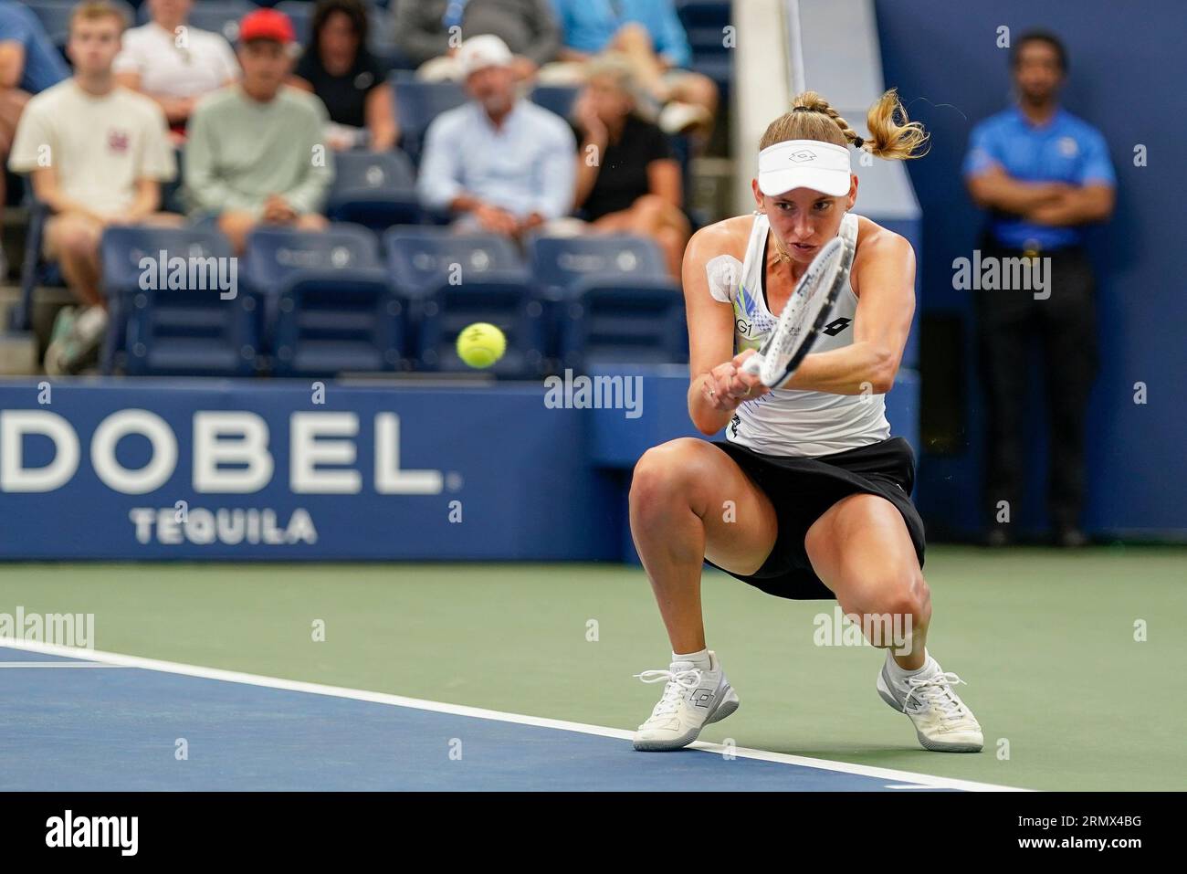 Elise Mertens, of Belgium, returns a shot to Danielle Collins, of the ...