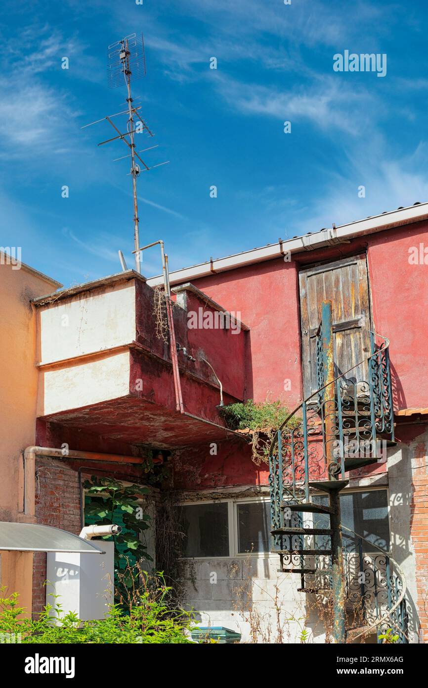 Roman traditional courtyard with balcony and old door against a blue ...