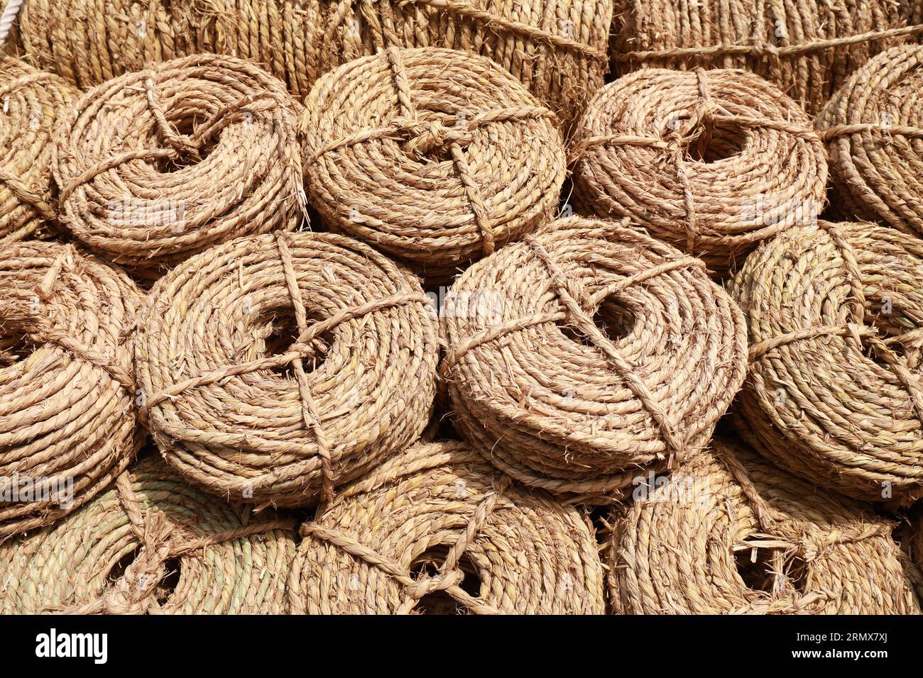 Rolls of straw rope piled together Stock Photo - Alamy