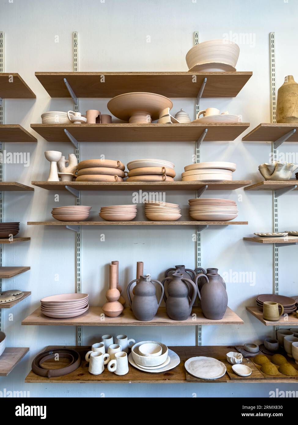 Handmade ceramic pieces drying before being bisque fired Stock Photo ...