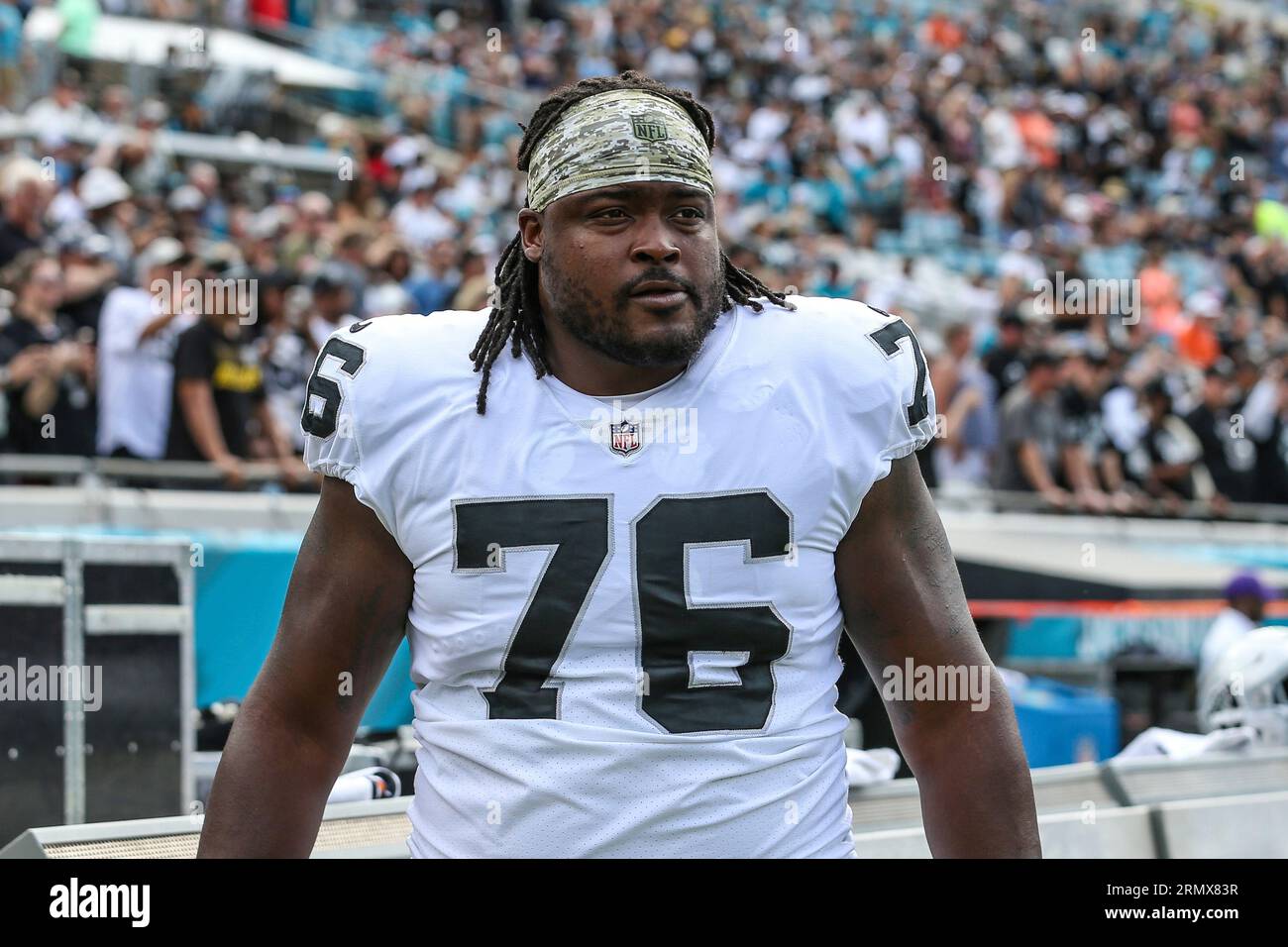 FILE - Las Vegas Raiders guard John Simpson (76) walks the sideline ...