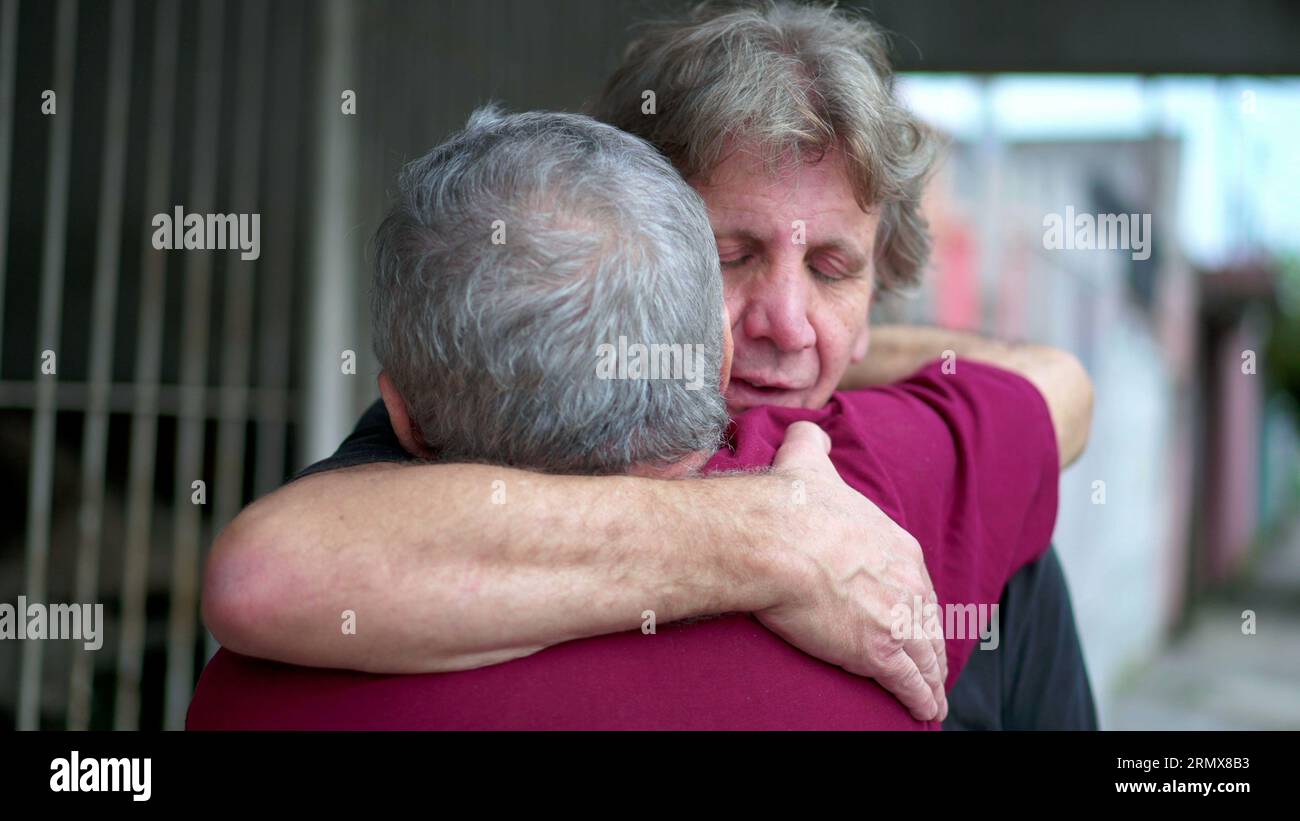 Heart-warming embrace between two senior friends in authentic loving ...
