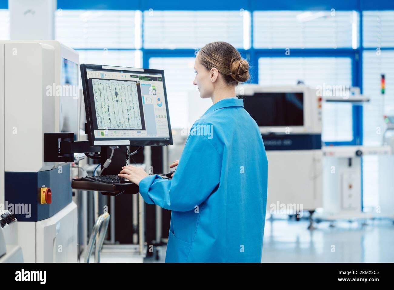 Manufacturing worker checking data of assembly line on screen Stock ...