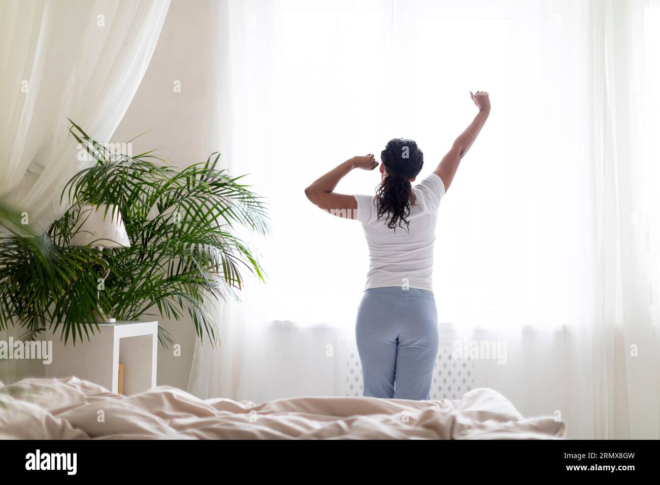 African american woman waking up stretching arms hi-res stock ...