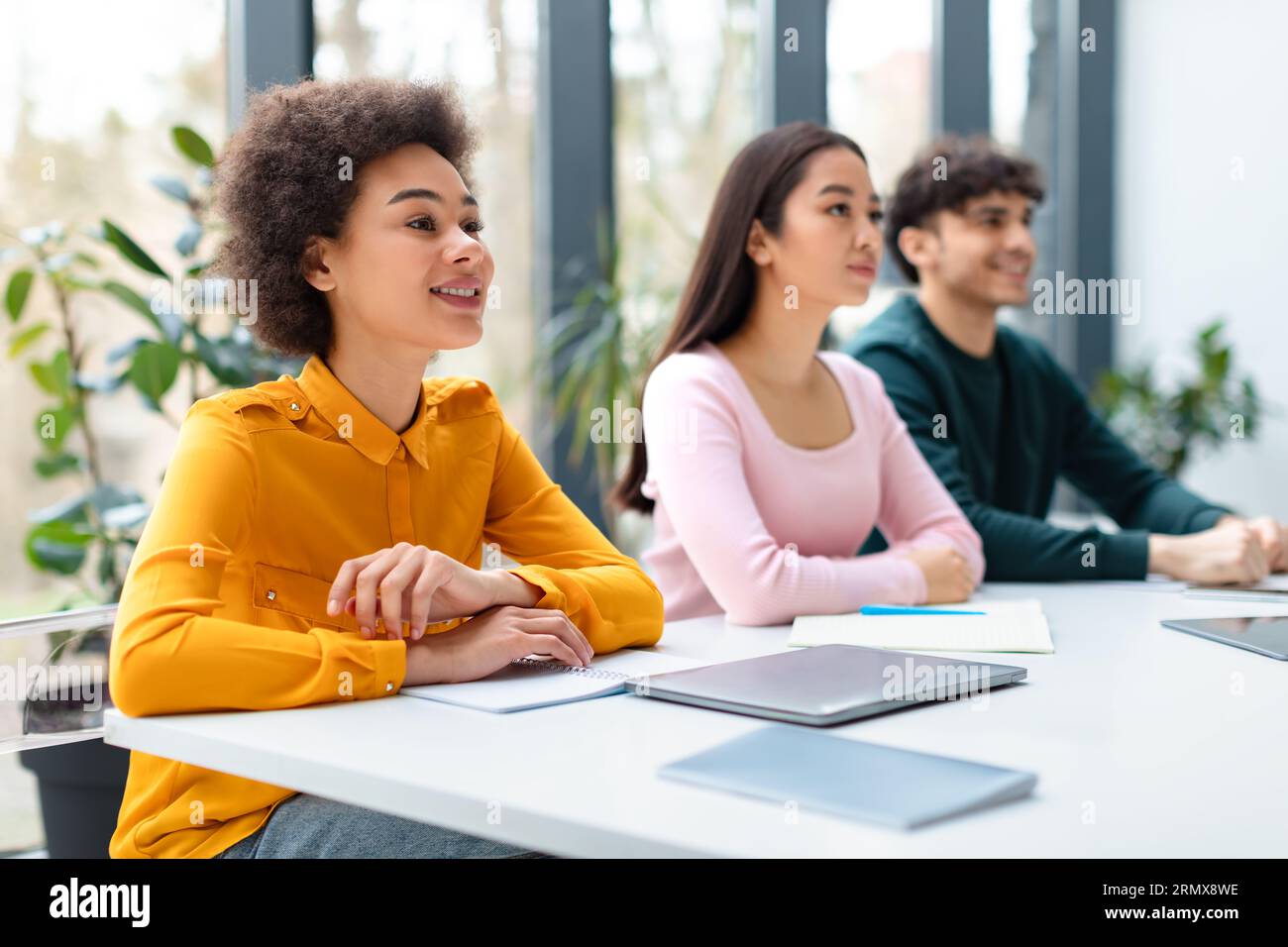 Cheerful lady looking aside listening hi-res stock photography and ...