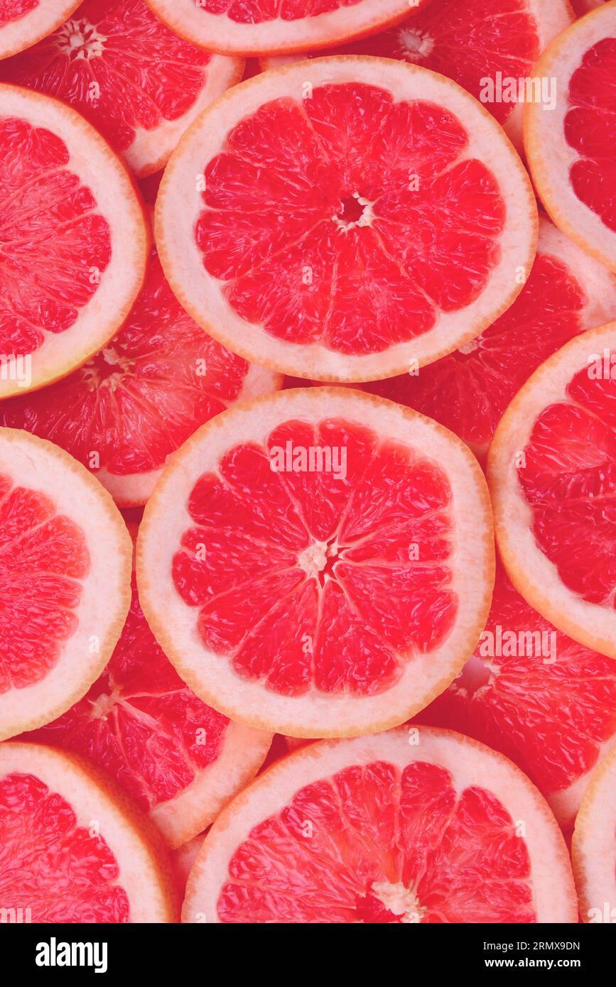 Grapefruit red juicy slices background. top view Stock Photo - Alamy