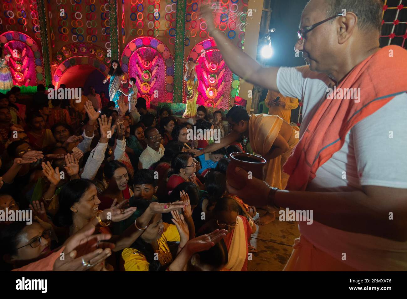 Howrah,West Bengal,India- 3rd October, 2022 : Hindu purohit spraying ...