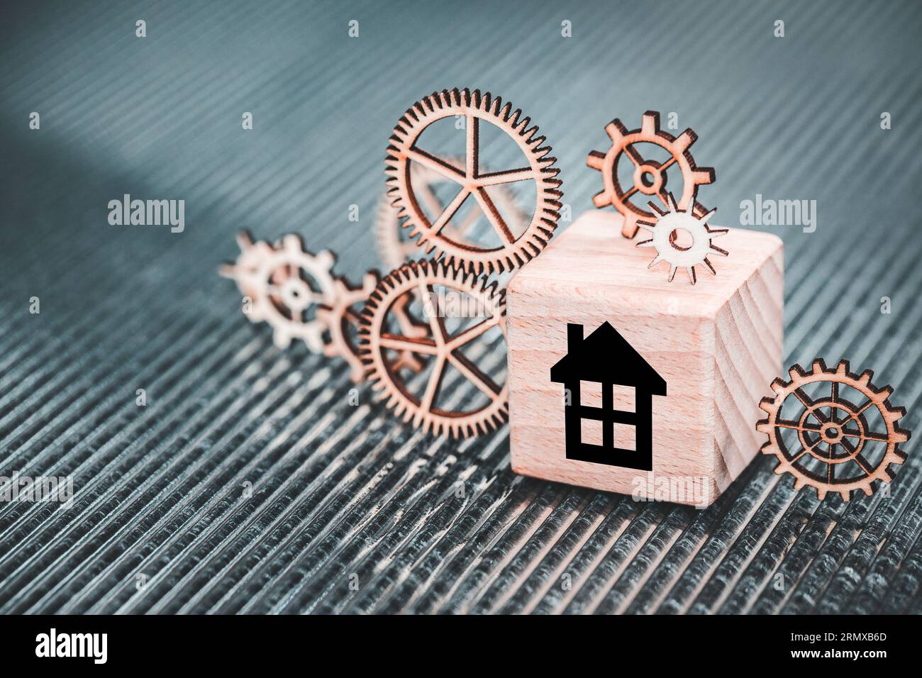 House symbol on a wooden block, clock gears and mechanisms, smart home ...