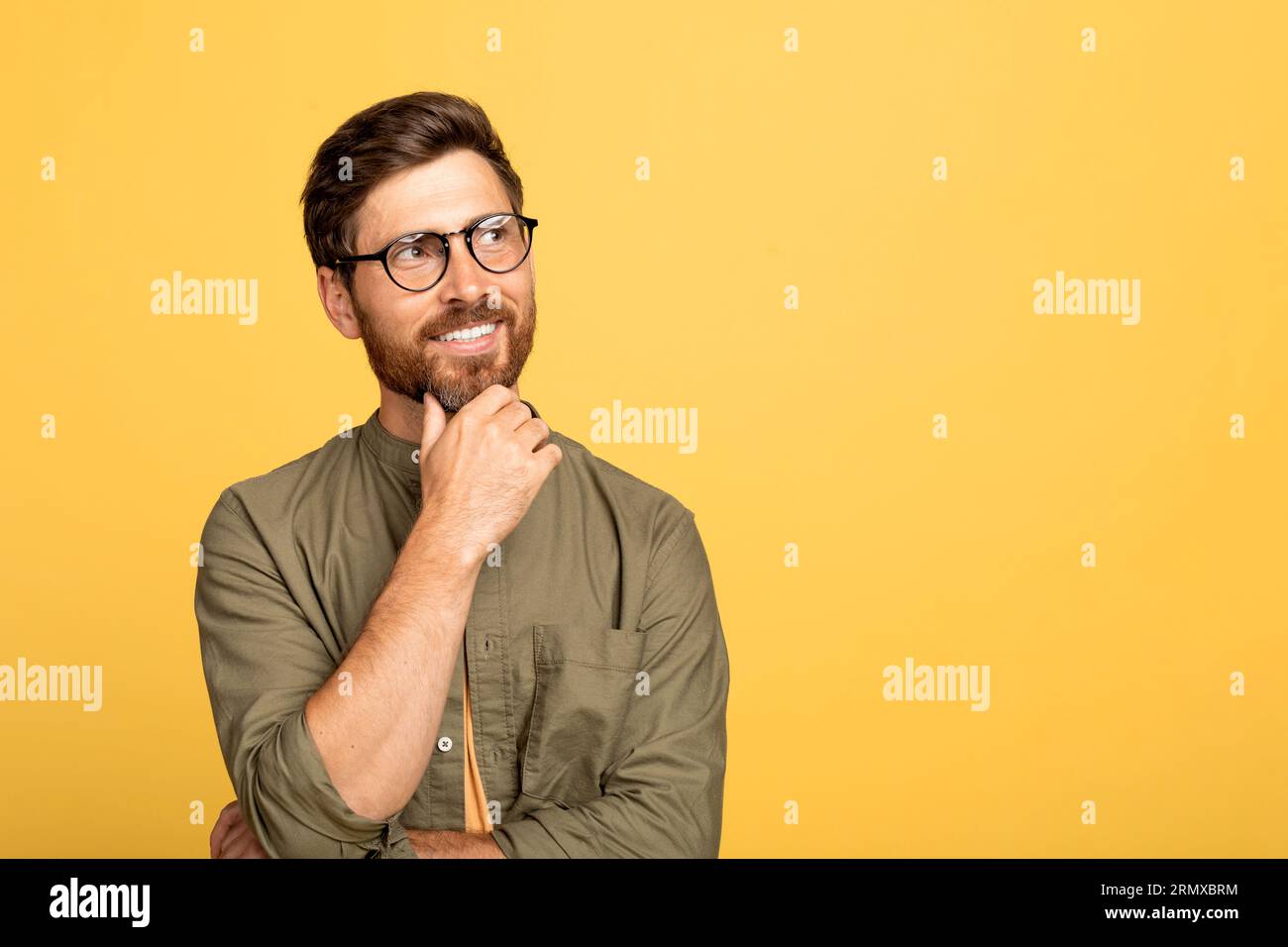 Interesting deal. Cheerful handsome middle aged man looking aside at ...