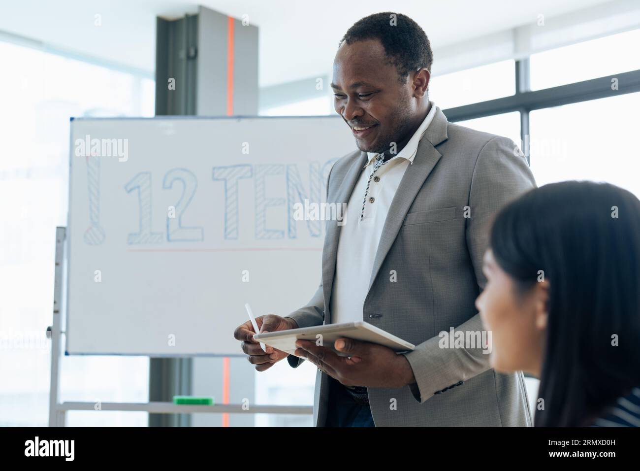 Mature african american professor talking to his student while teaching ...