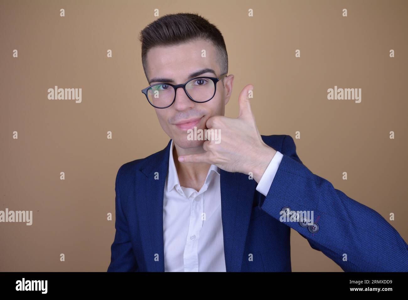Young Handsome Elegant Man Gesturing 'Call Me' with Hand Sign on ...
