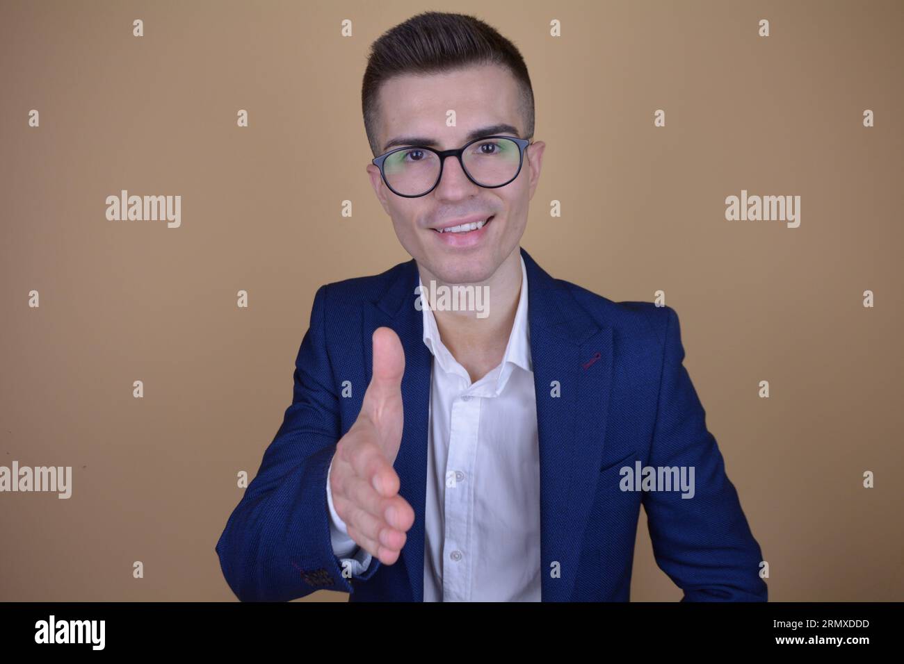 Smiling Young Handsome Elegant Man Extending Hand in Greeting on ...