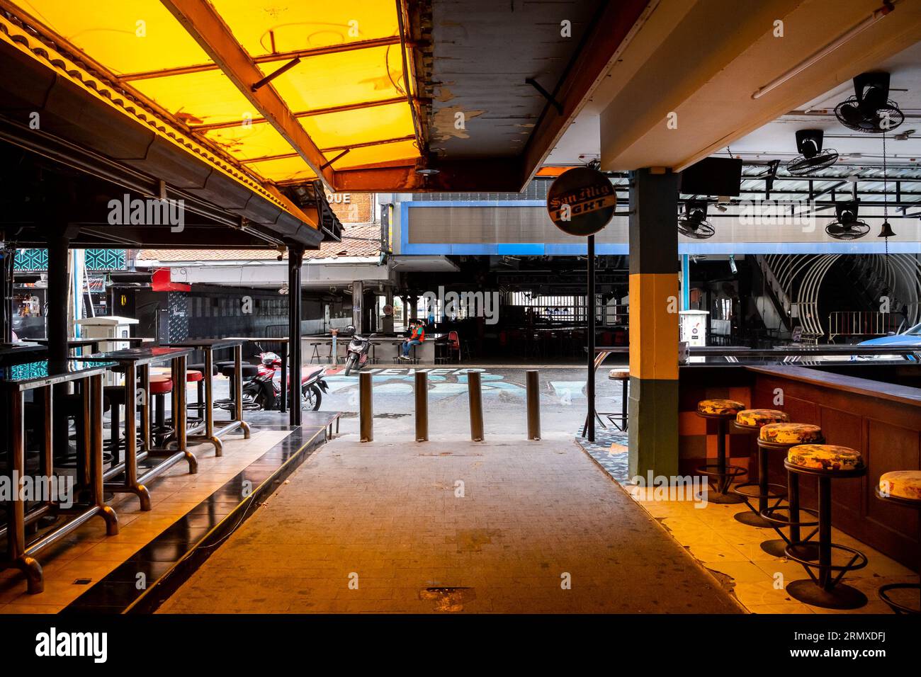 Looking through the some empty beer bars on to Walking Street, Pattaya ...