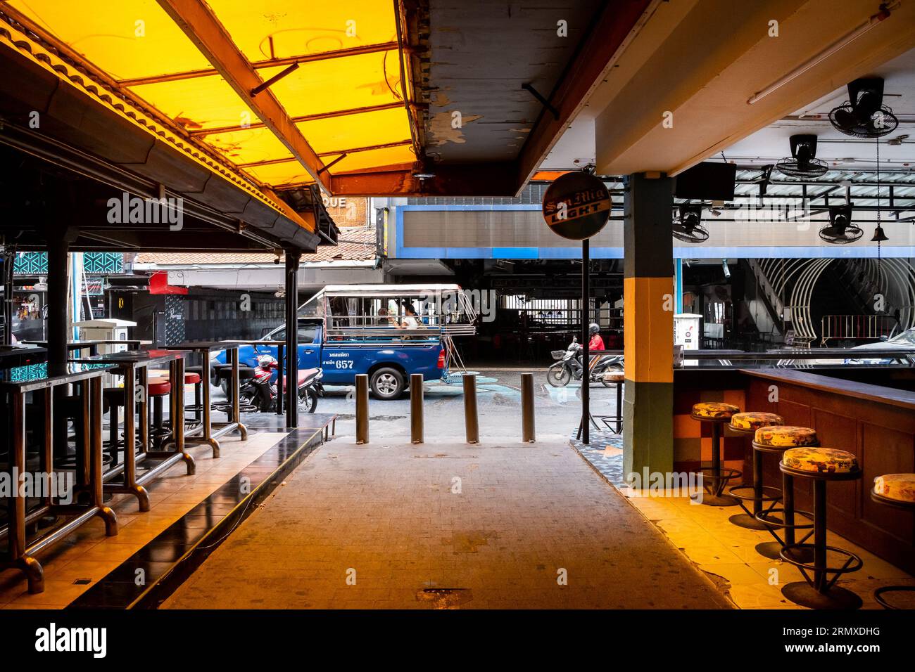 Looking through the some empty beer bars on to Walking Street, Pattaya ...