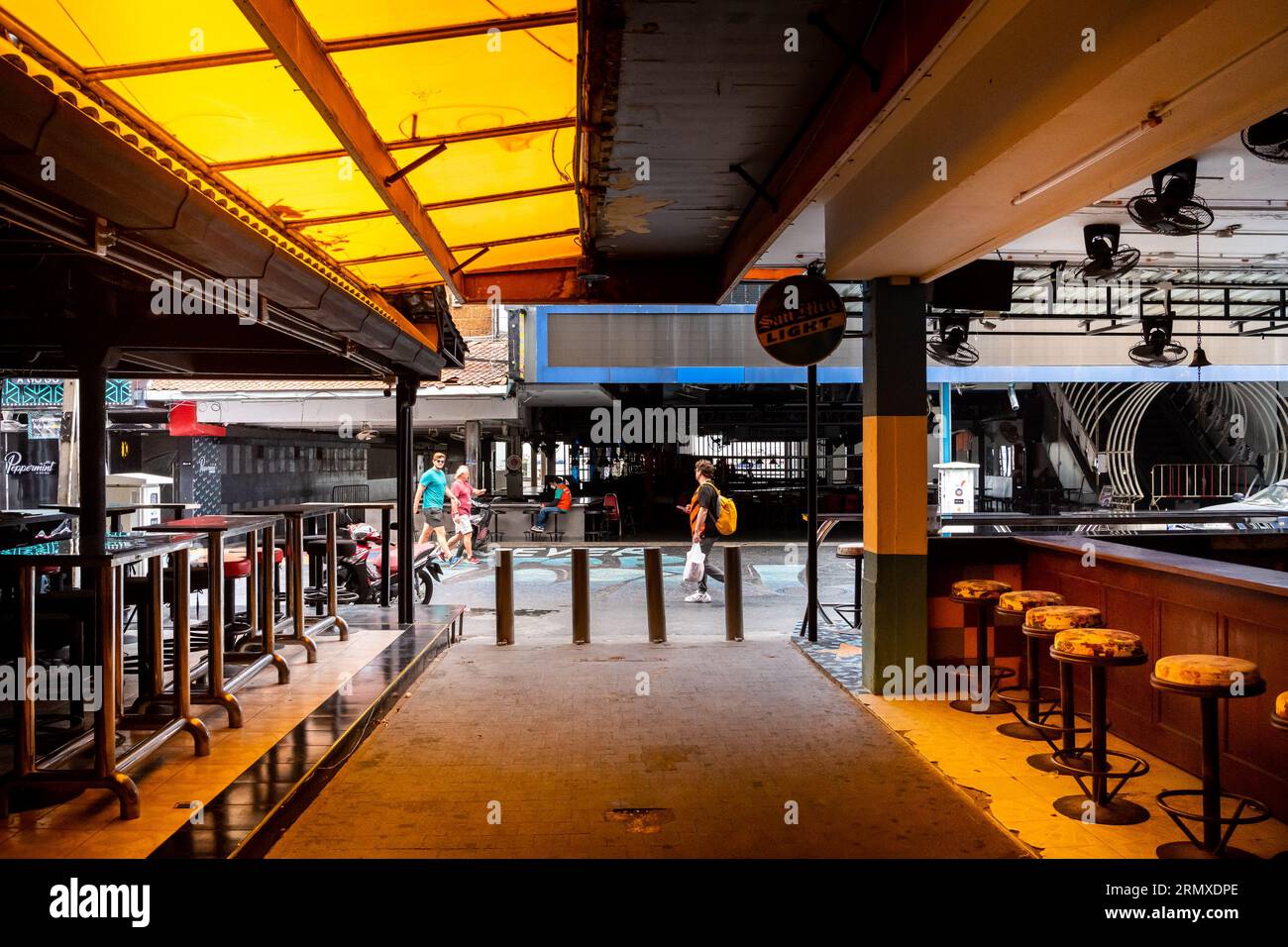 Looking through the some empty beer bars on to Walking Street, Pattaya ...