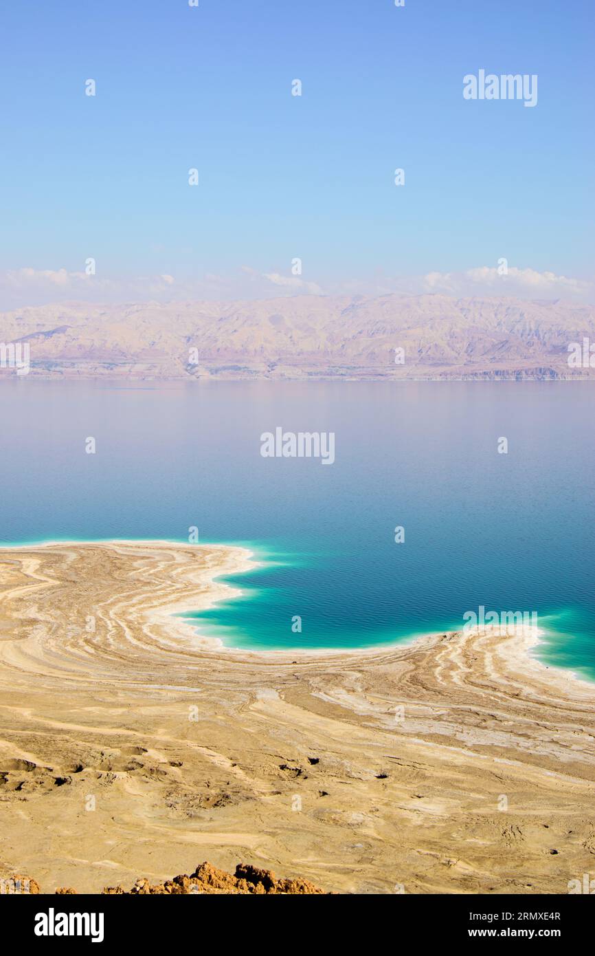 Aerial view of the Dead Sea from a rocky cliff, featuring the deep blue ...