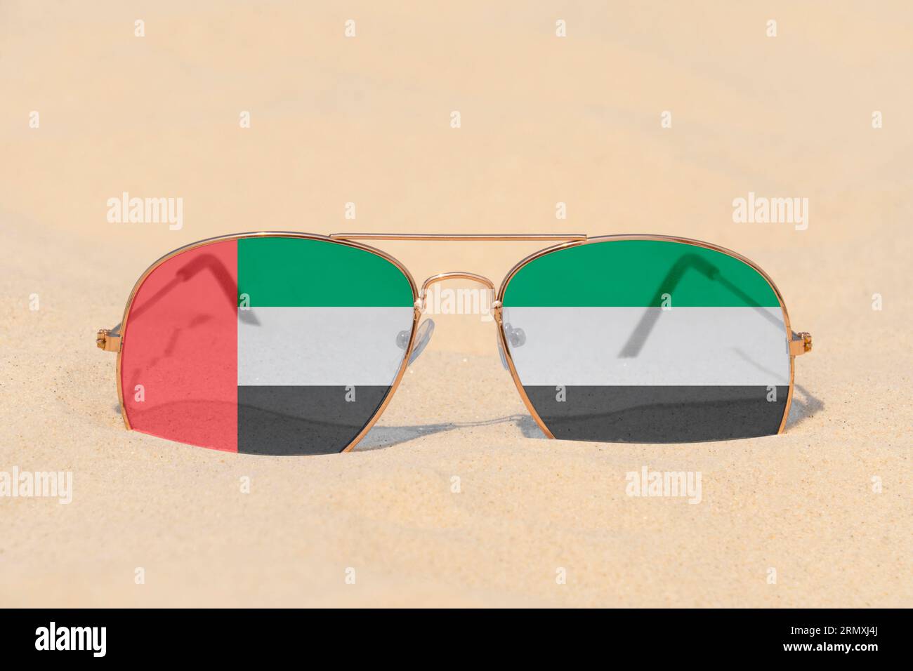 Sunglasses with glasses in form of flag of United Arab Emirates lie on ...