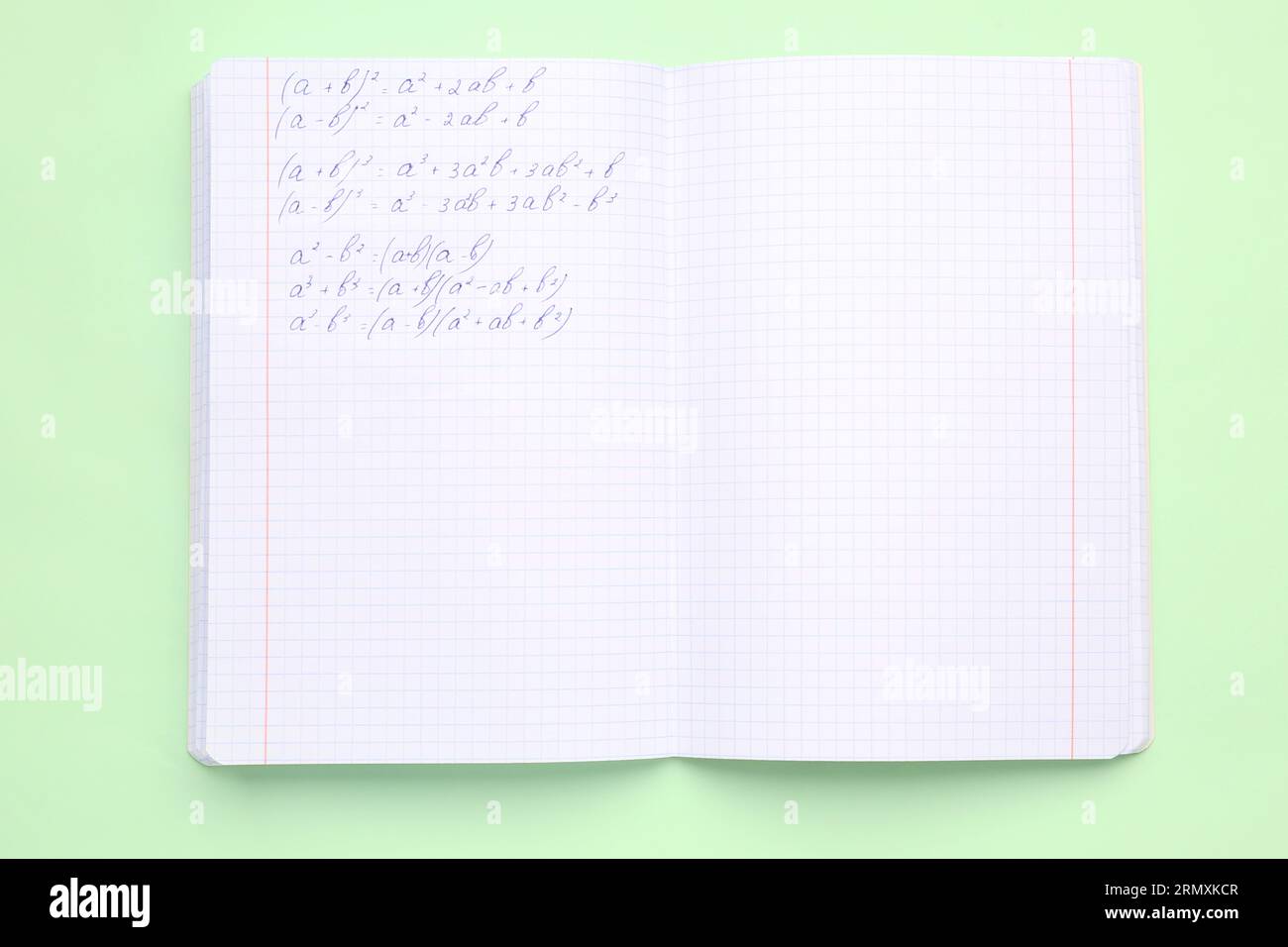 Copybook with maths formulas on green background Stock Photo - Alamy
