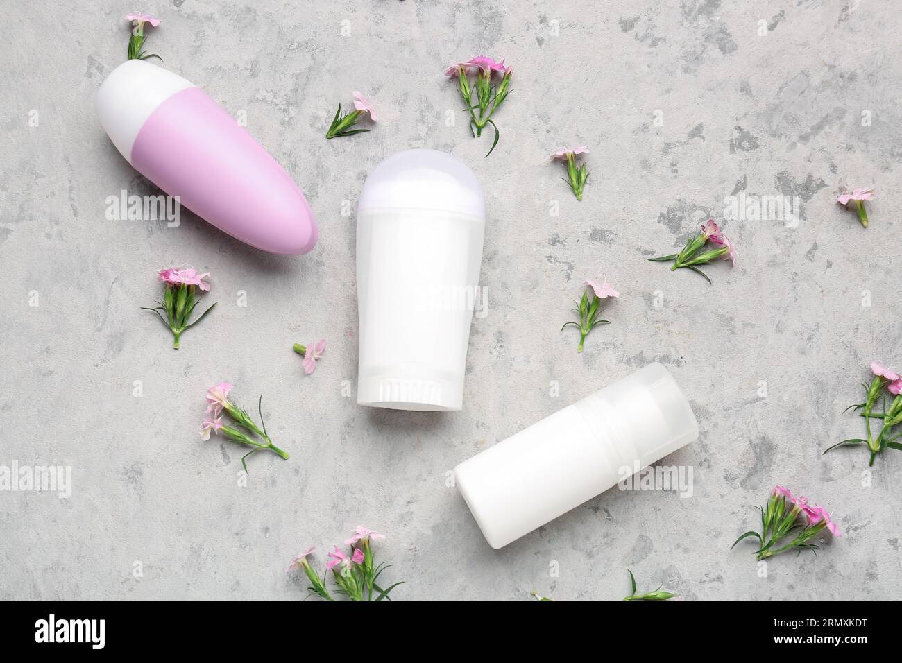 Different deodorants and flowers on grunge background Stock Photo - Alamy