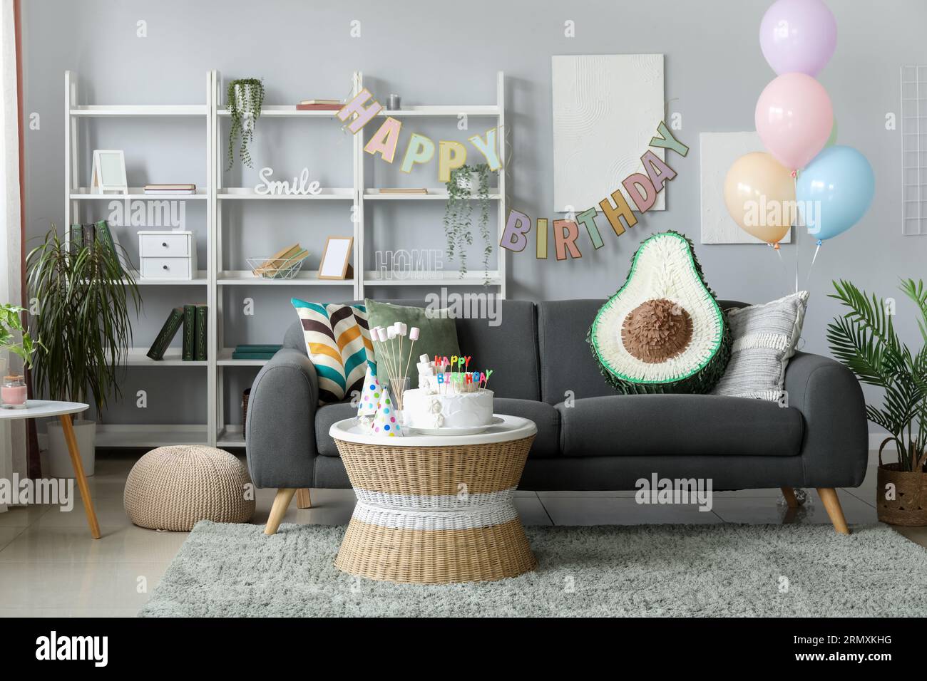 Interior of living room with birthday cake, balloons and pinata on grey ...