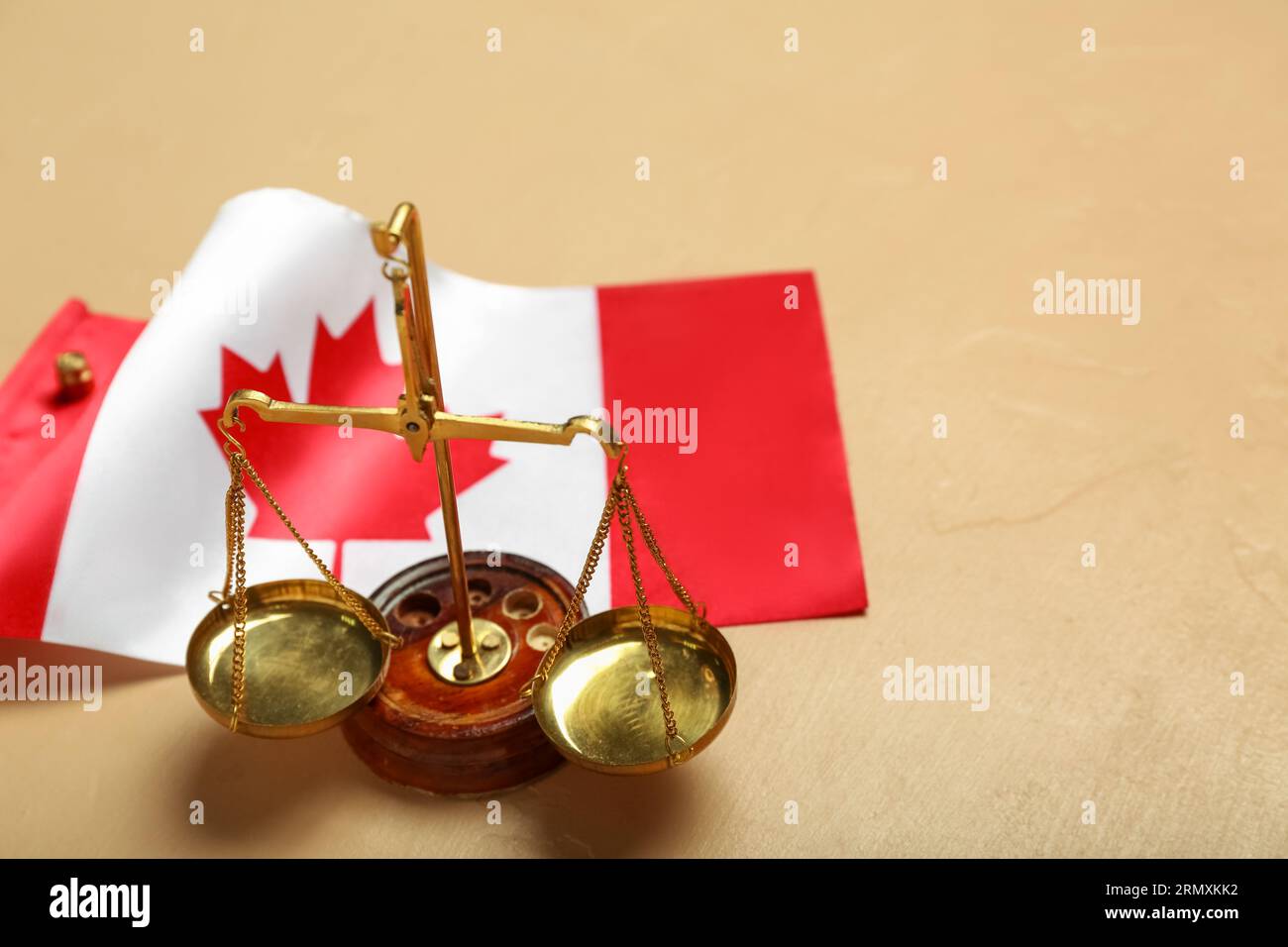 Flag of Canada with justice scales on beige background, closeup Stock ...