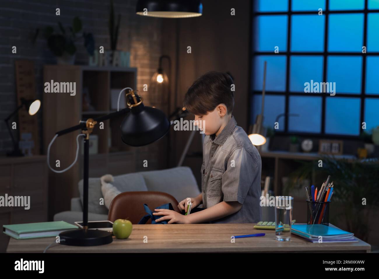 School boy studying night in hi-res stock photography and images - Alamy