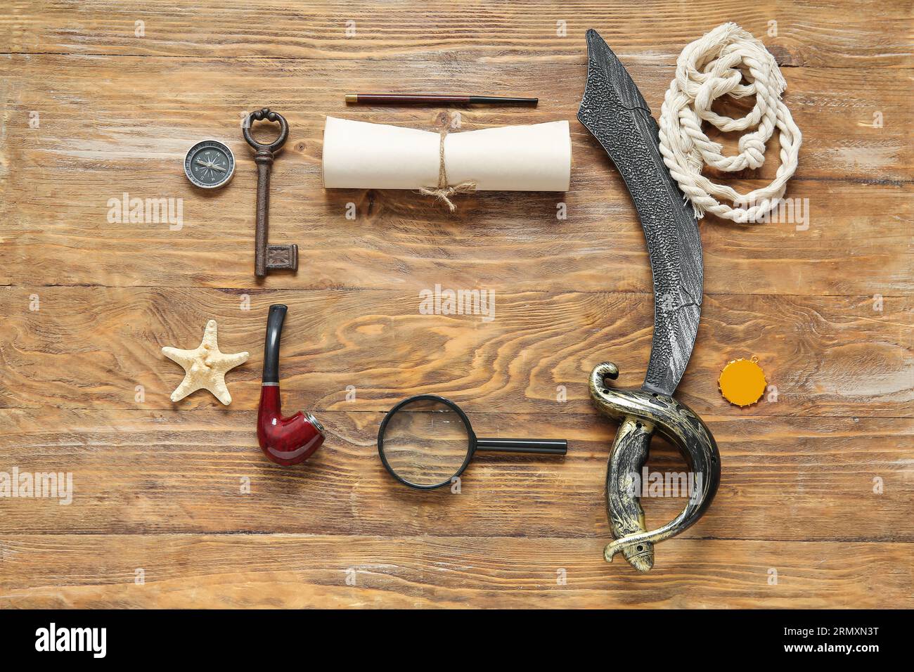 Different pirate equipment on brown wooden background Stock Photo - Alamy