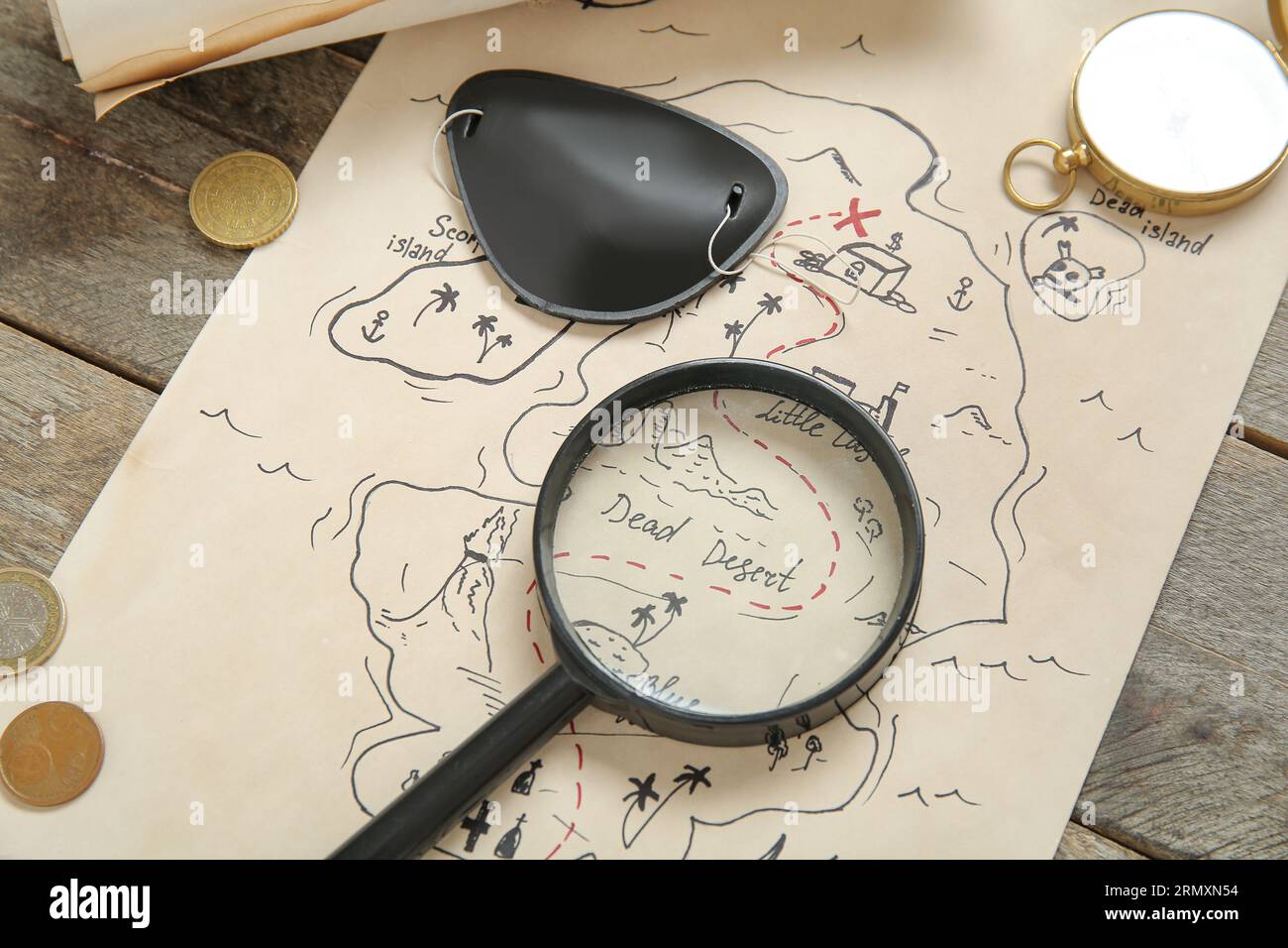 Treasure map with pirate eye patch, magnifier and coins on brown wooden ...
