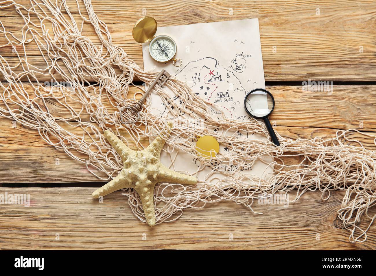 Treasure map with pirate amulet, magnifier, compass and net on brown ...