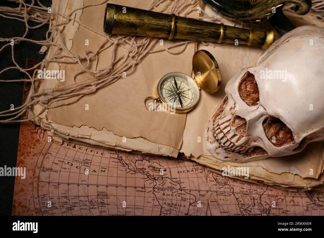 Human skull with spyglass, old manuscripts, world map and compass on ...