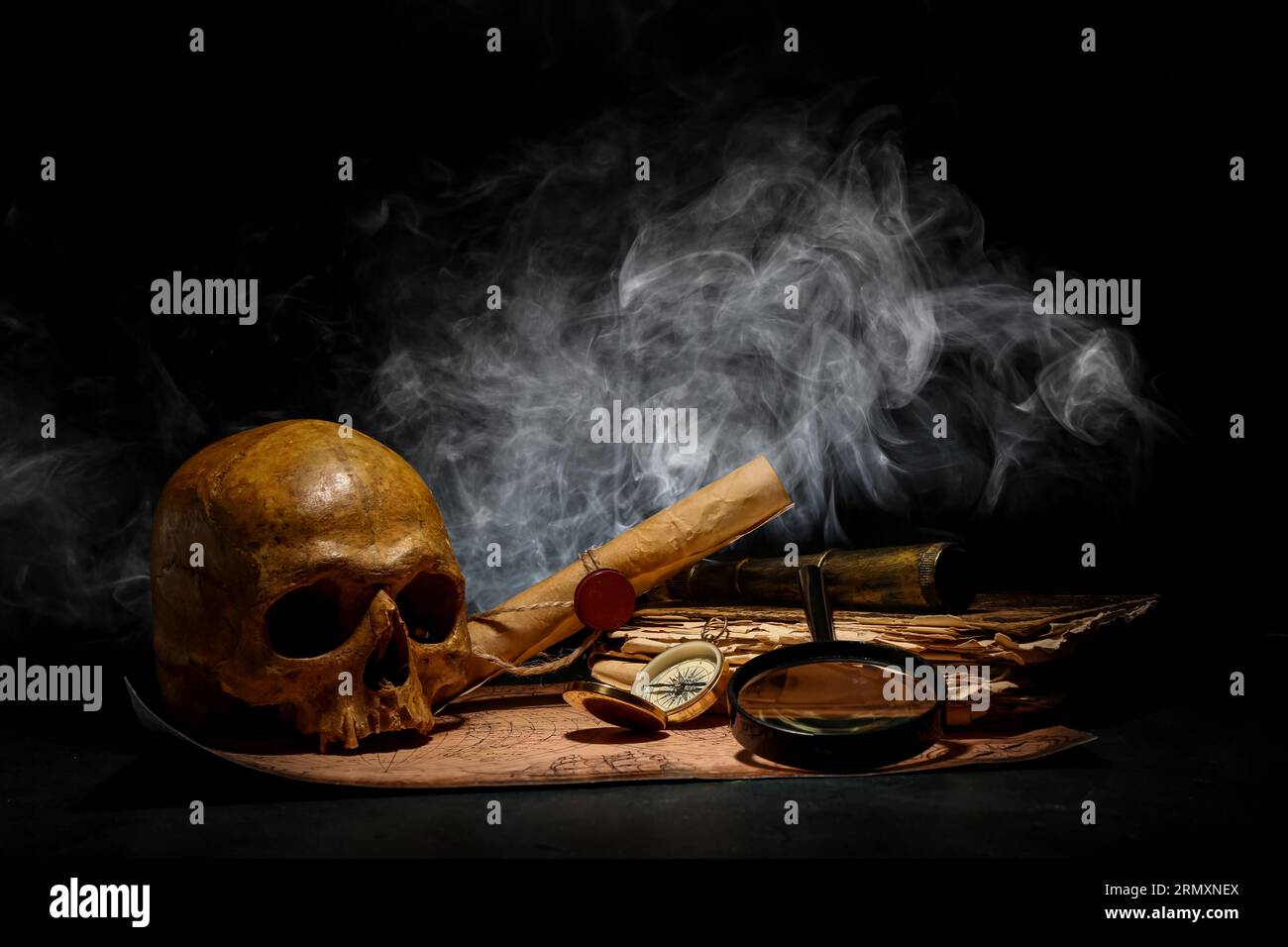 Human skull with old manuscripts, travel equipment and world map on ...