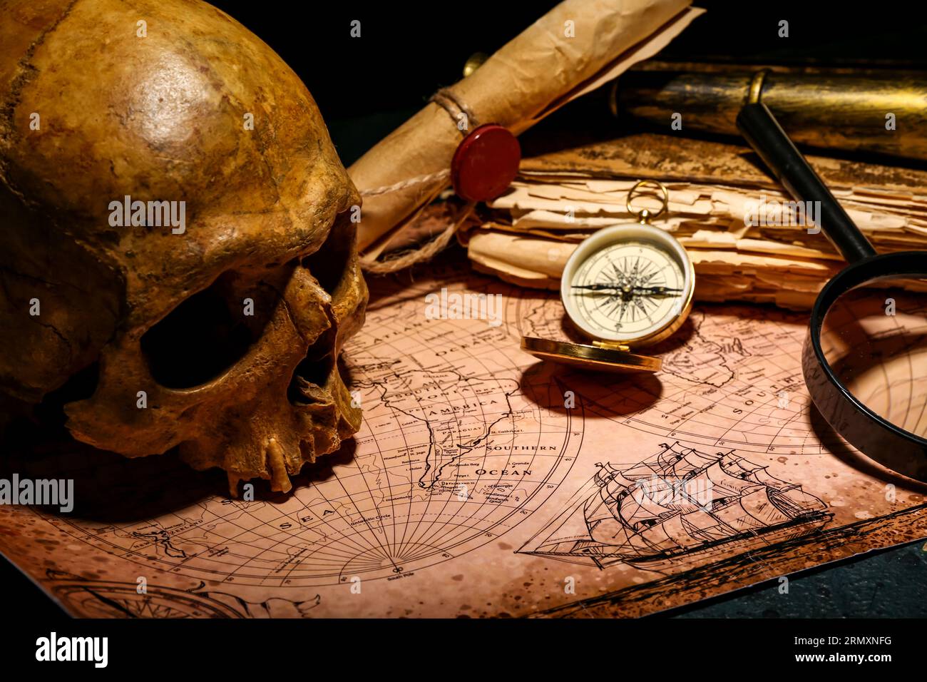 Human skull with old manuscripts, travel equipment and world map on ...