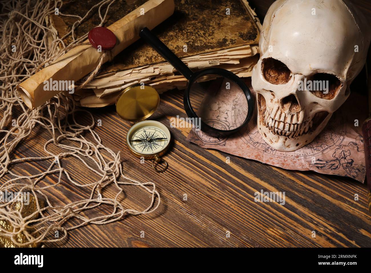Human skull with old manuscripts, world map and travel equipment on ...