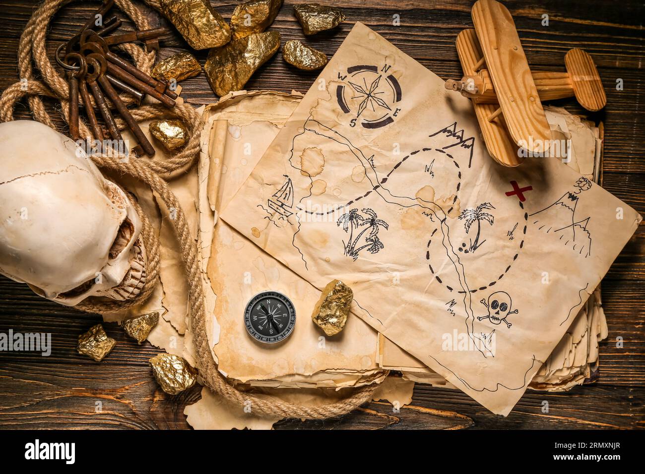 Human skull with treasure map, old manuscripts and golden nuggets on ...