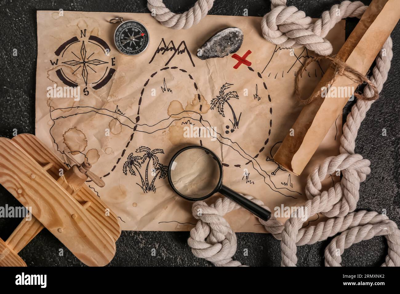 Treasure map with travel equipment, toy airplane and golden nuggets on ...